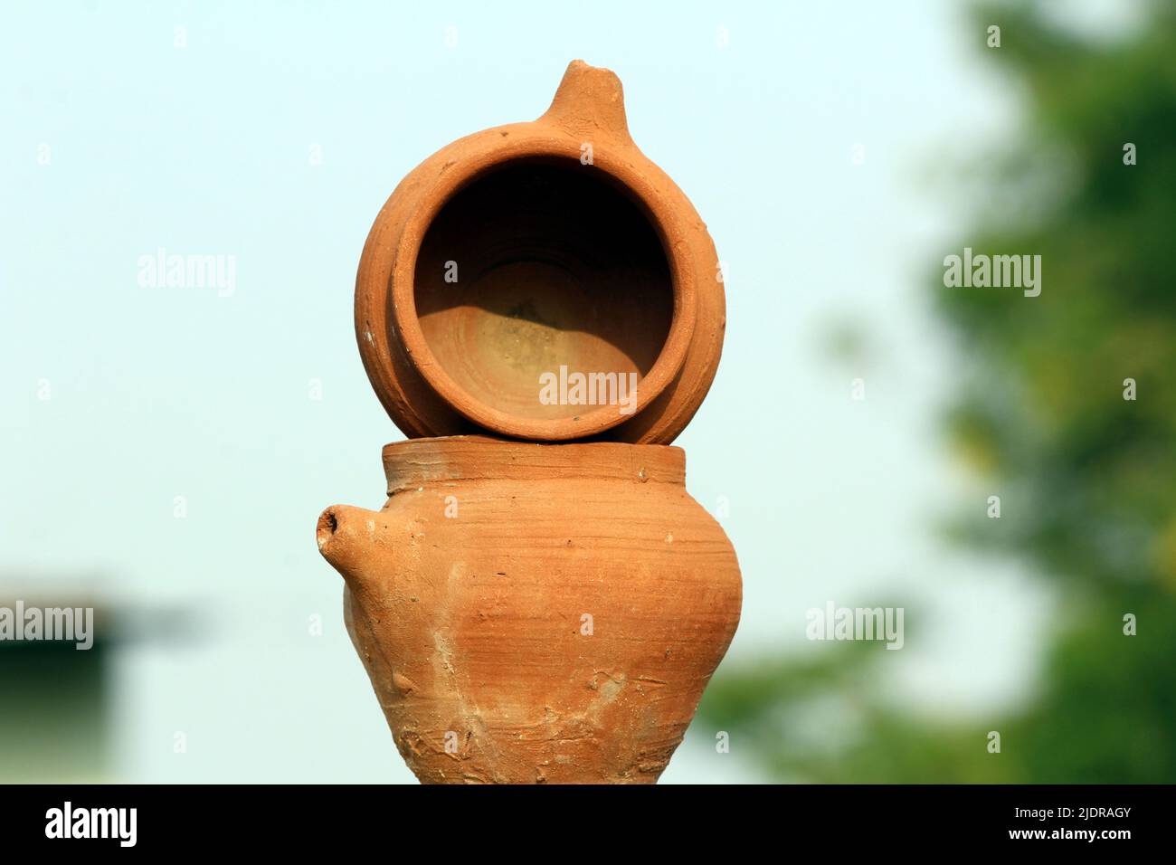 red color clay pot put on a stone Stock Photo - Alamy