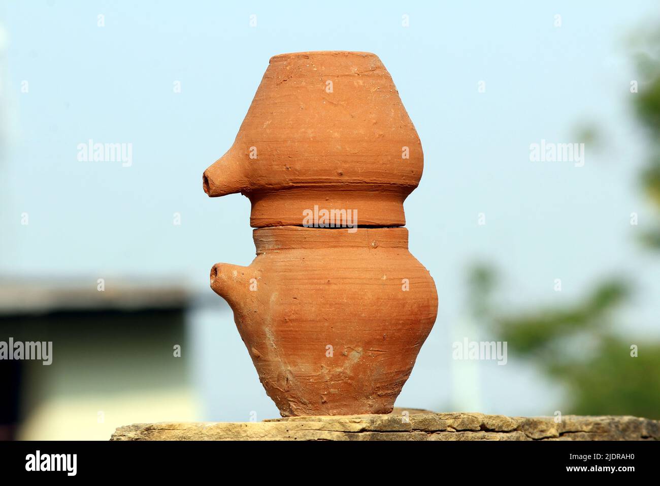 red color clay pot put on a stone Stock Photo - Alamy