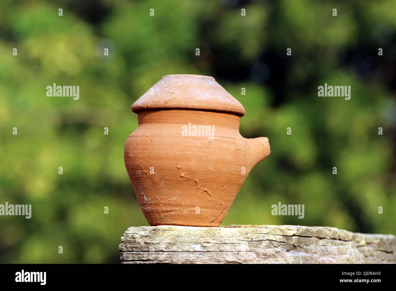 red color clay pot put on a stone Stock Photo - Alamy