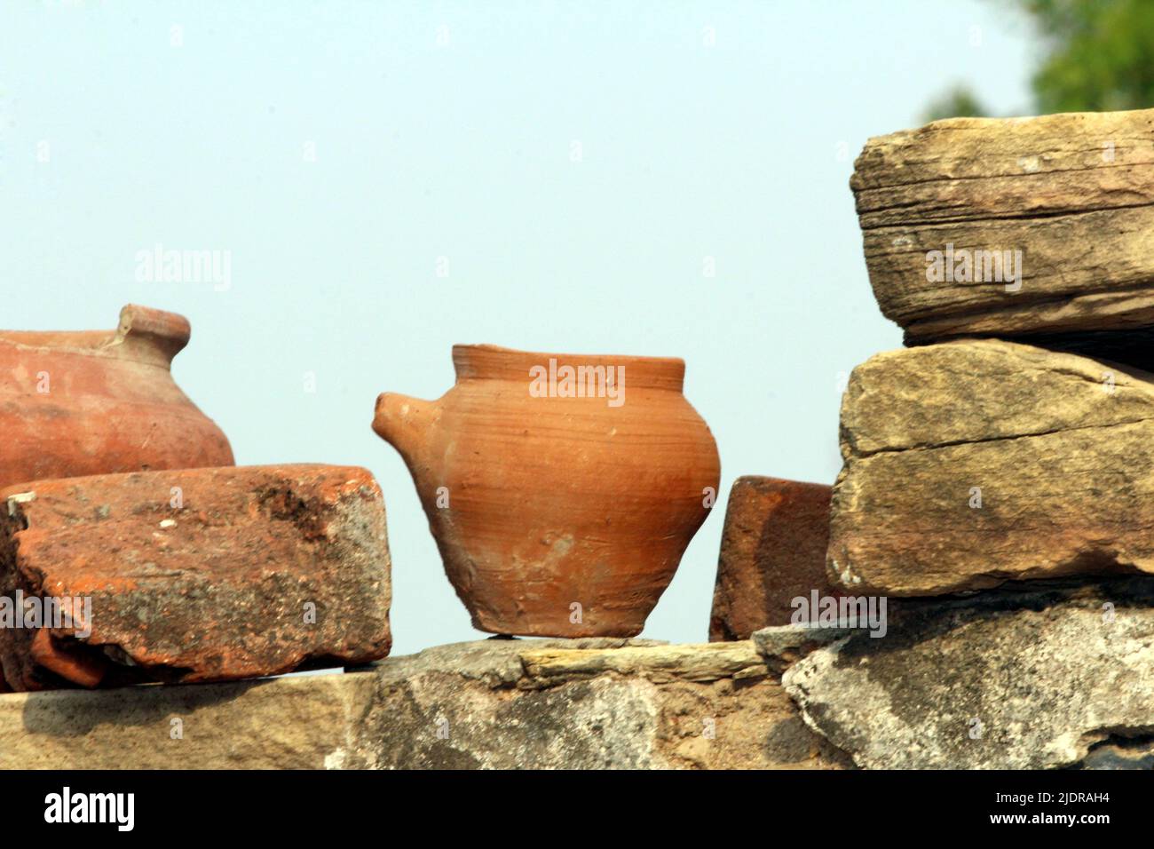 red color clay pot put on a stone Stock Photo - Alamy