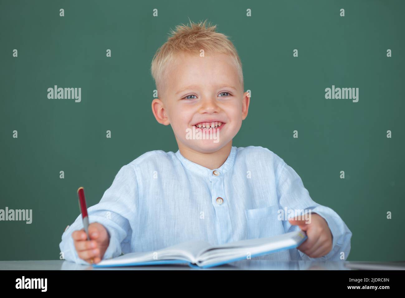 School child student learn lesson sitting at desk studying. Kid writing ...