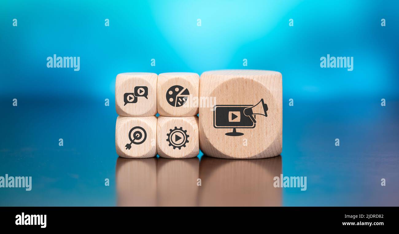 Wooden blocks with symbol of video marketing concept on blue background ...