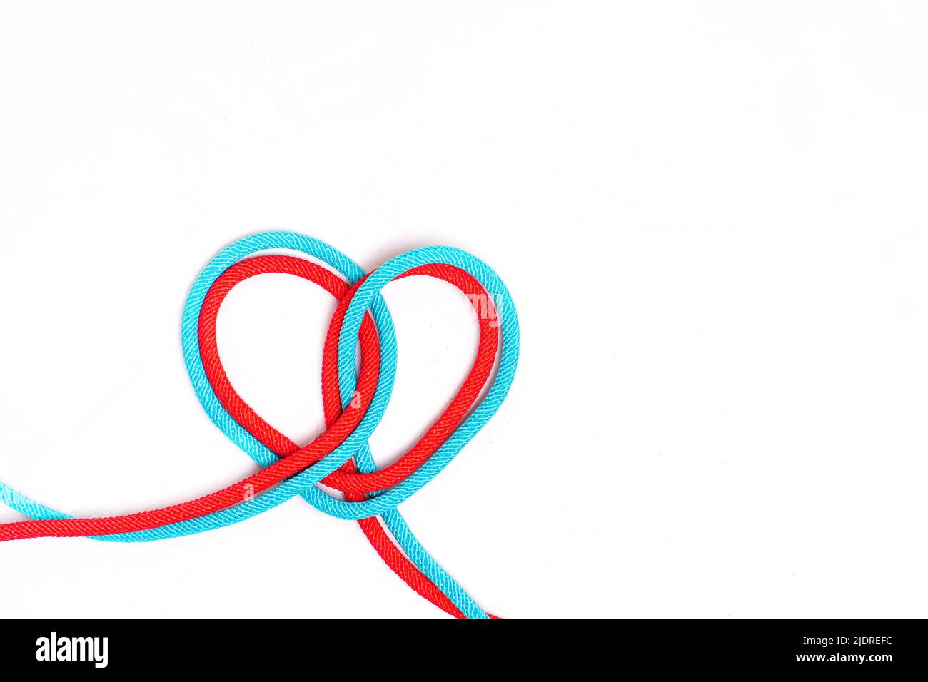 Heart symbol made from two braided cords isolated on gray background ...