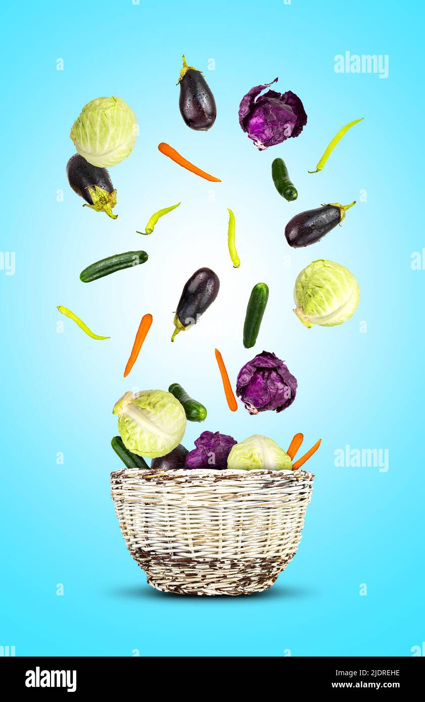 Fresh vegetables falling in the wooden basket Stock Photo - Alamy
