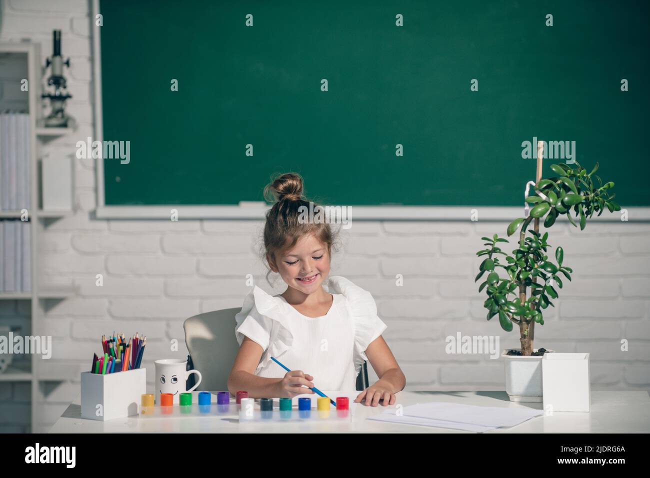 Cute little girl child painting with paints color and brush. Drawing ...