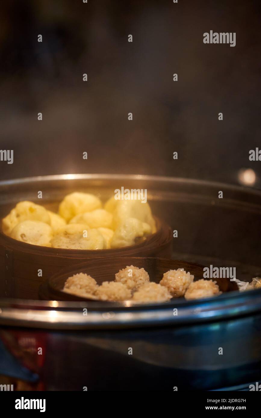 Cantonese morning tea dim sum is being cooked in a steamer in a Chinese ...