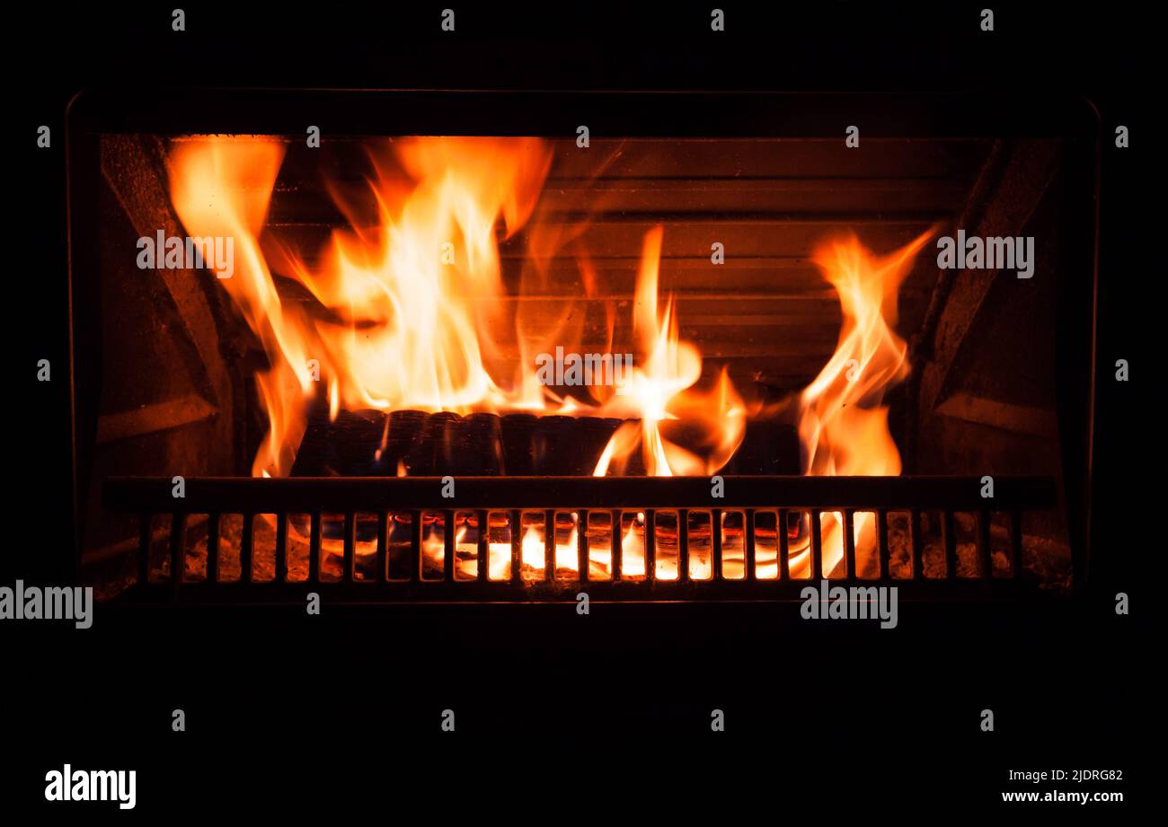 Fire burns in a fireplace at night, abstract background photo Stock ...