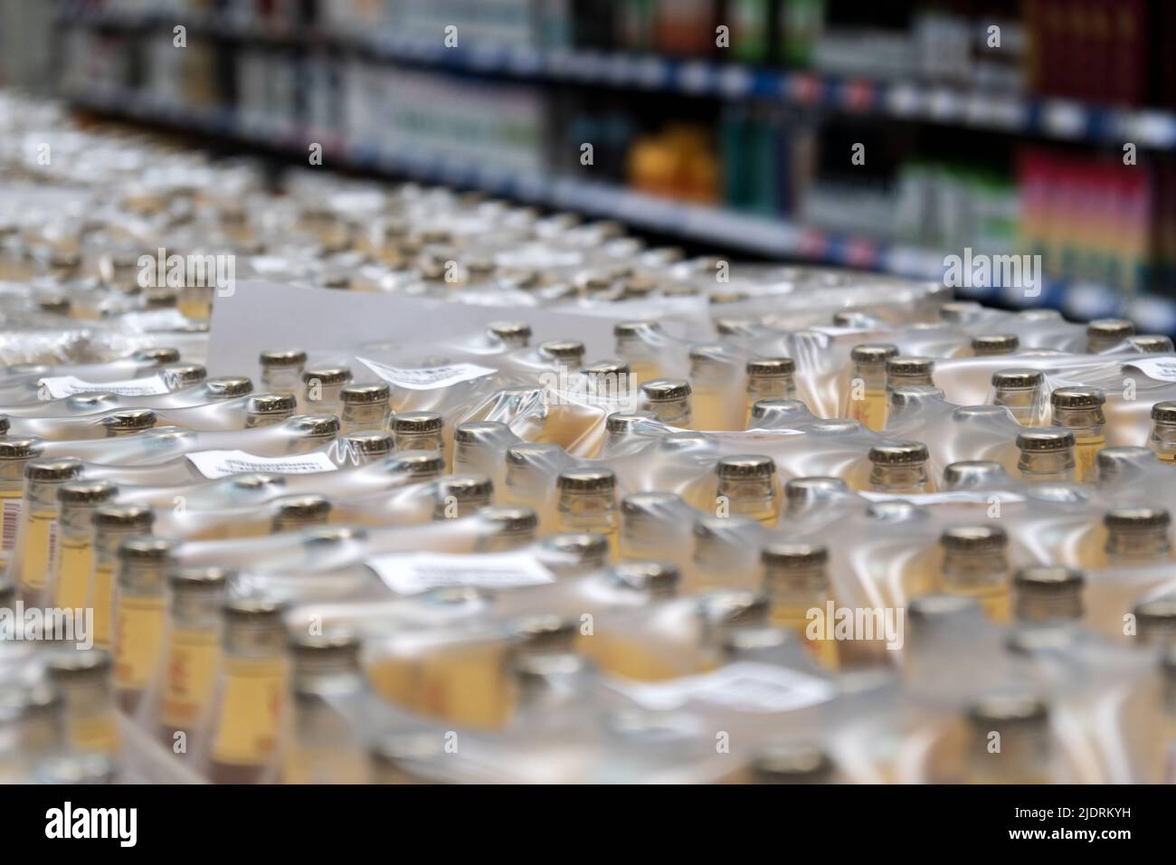 A lot of beer bottles, wholesale alcohol in a hypermarket. Selective ...