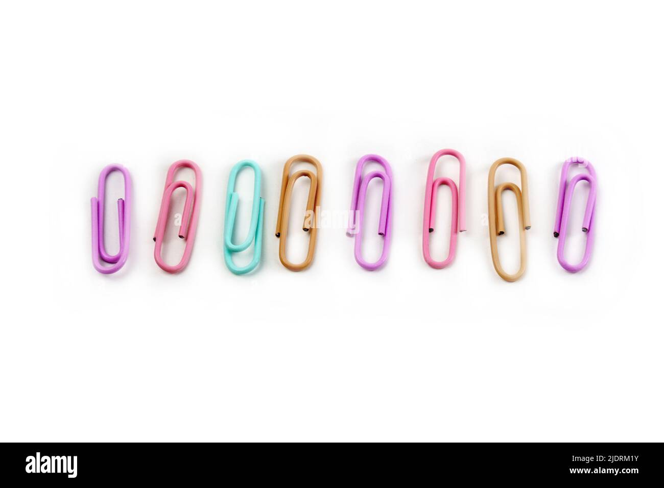 Multicolored paper clips close up isolated on white background ...