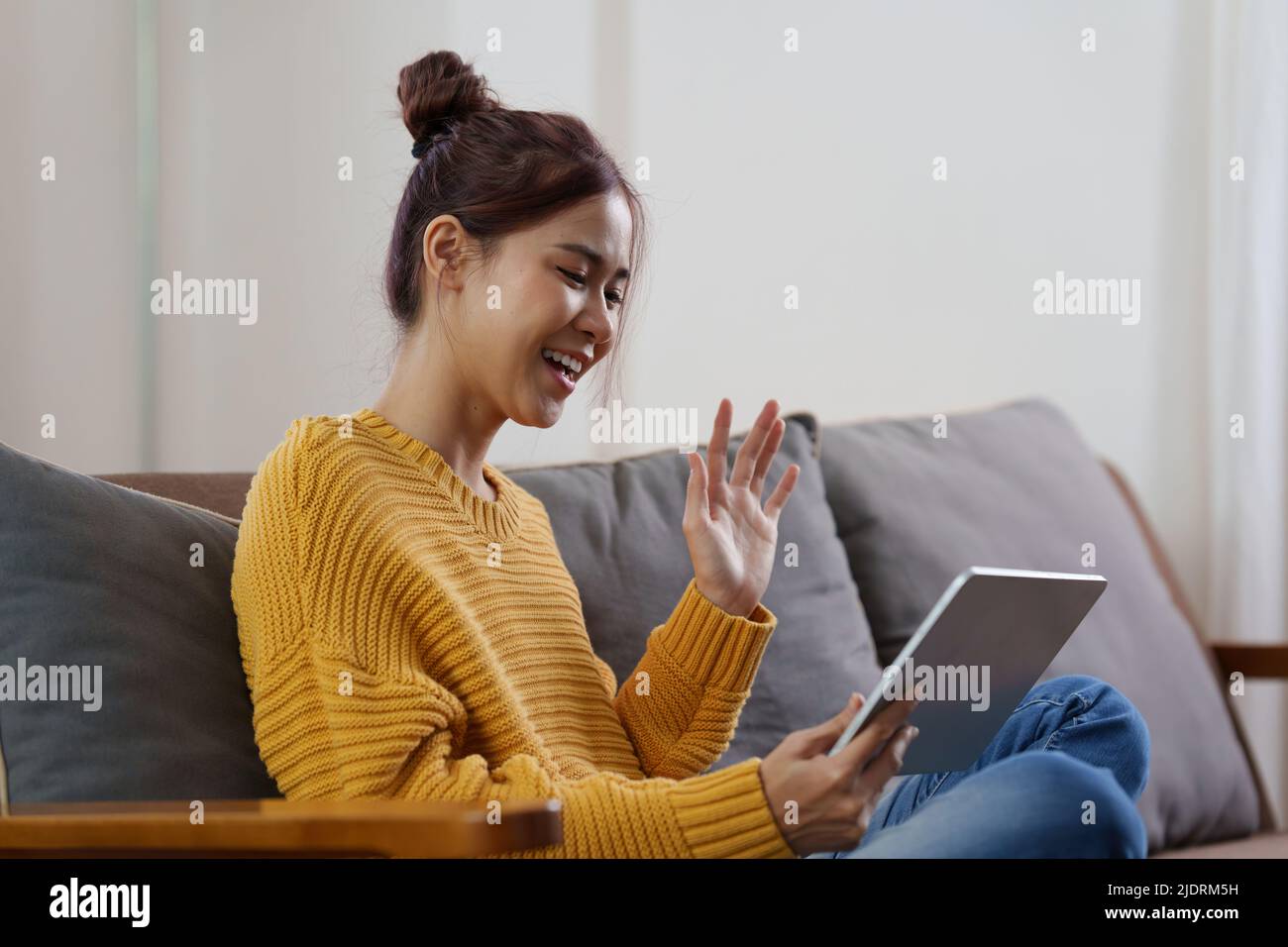 Portrait of happy asian beautiful girl making video calling with ...