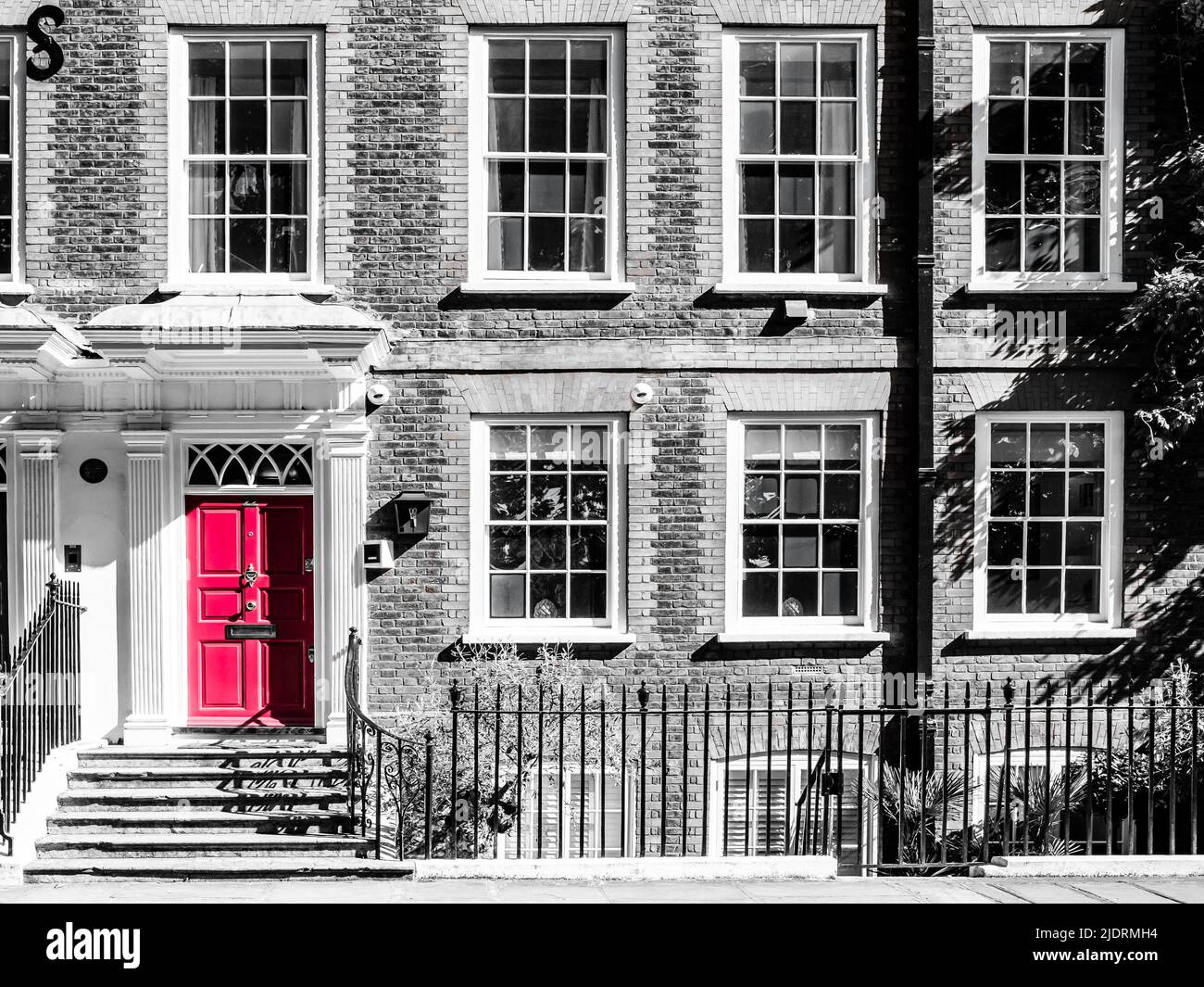 Georgian residential building desaturated with Red door Stock Photo - Alamy