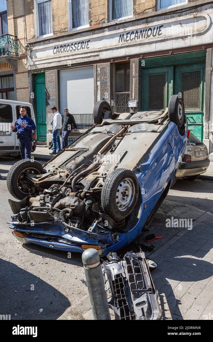 Driving accident: car on the roof in a street in Brussels Stock Photo ...