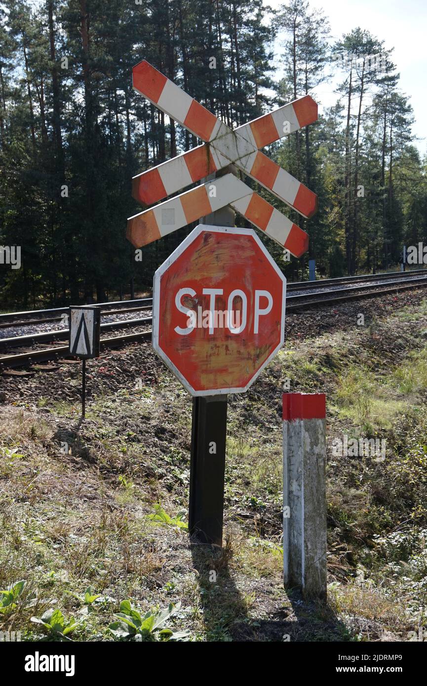 Stop sign on railroad crossing Stock Photo - Alamy