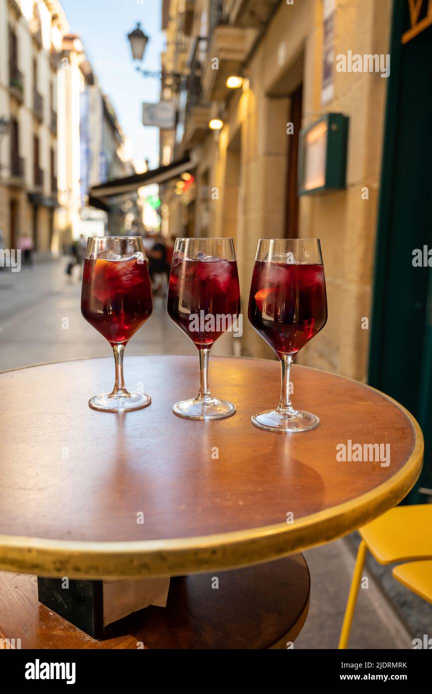 Glasses of cold sangria wine served outdoor in bar with view on old ...