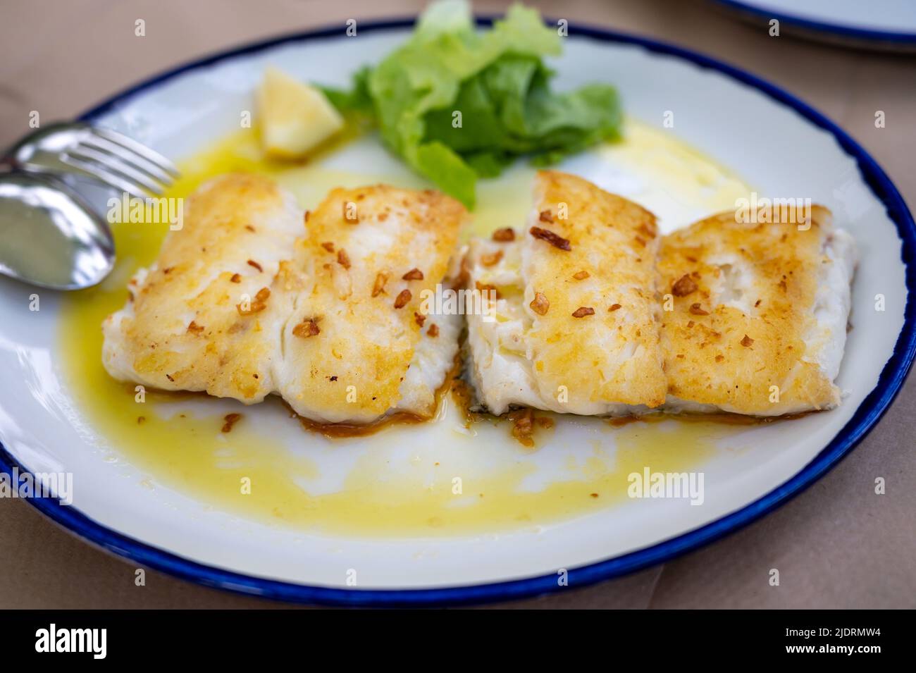 Grilled fillet of white codfish served in fish restaurant in San ...