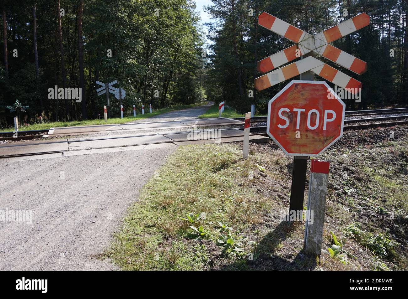 Stop sign on railroad crossing Stock Photo - Alamy