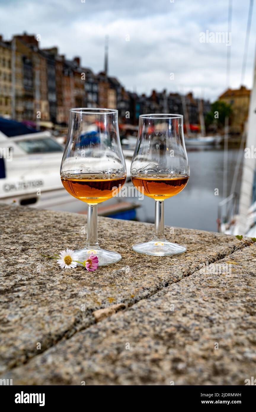 Tasting of apple calvados drink from glasses in old Honfleur harbour ...