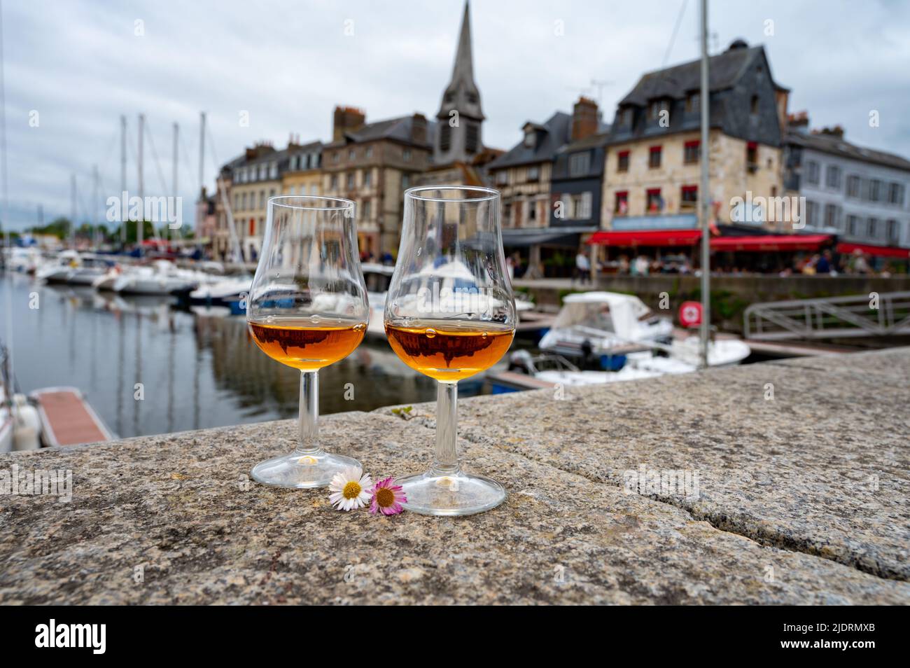 Tasting of apple calvados drink from glasses in old Honfleur harbour ...