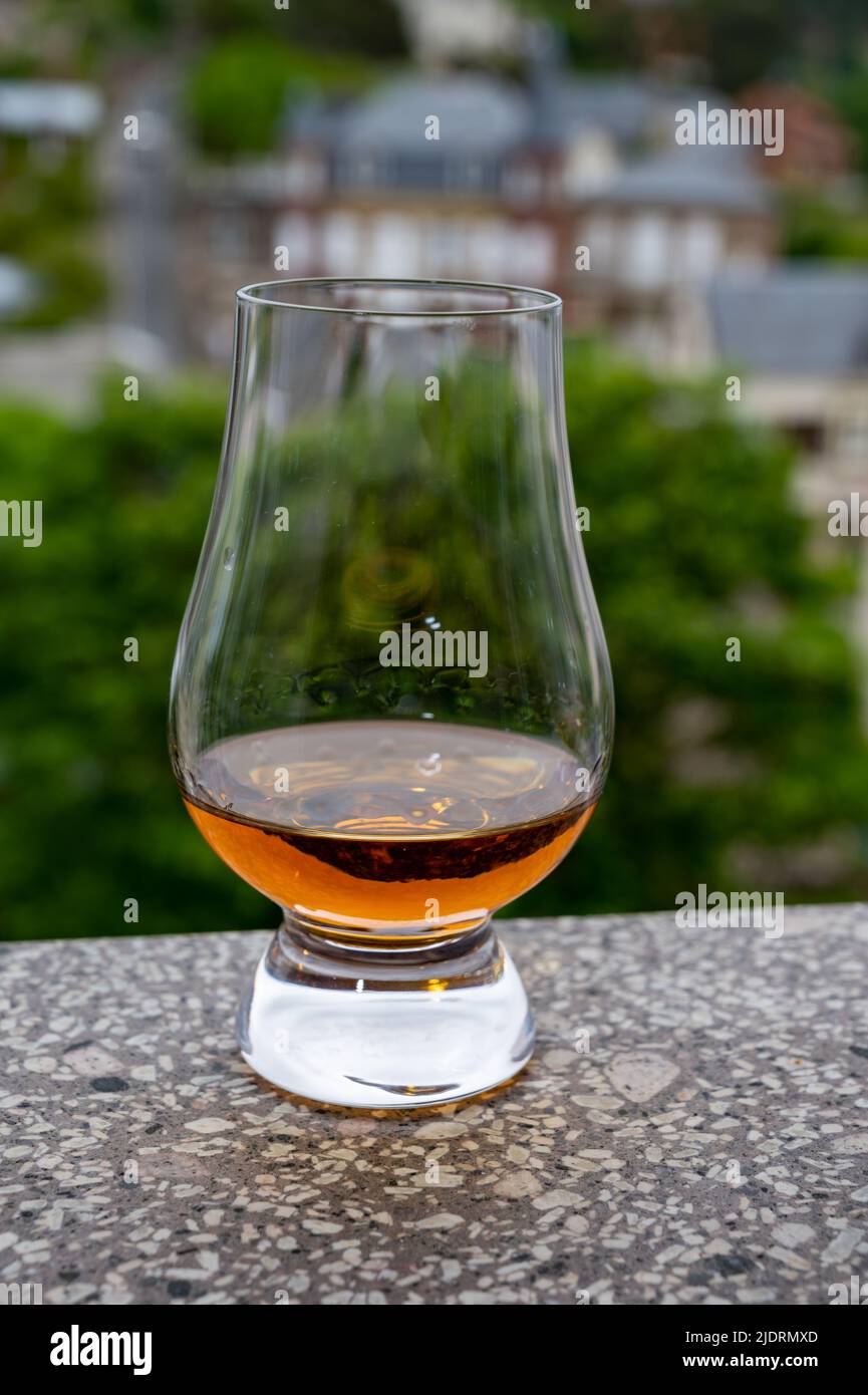 Dram of scotch whiskey with view on old houses on background, Edinburgh ...