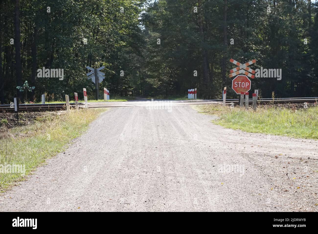 Stop sign on railroad crossing Stock Photo - Alamy