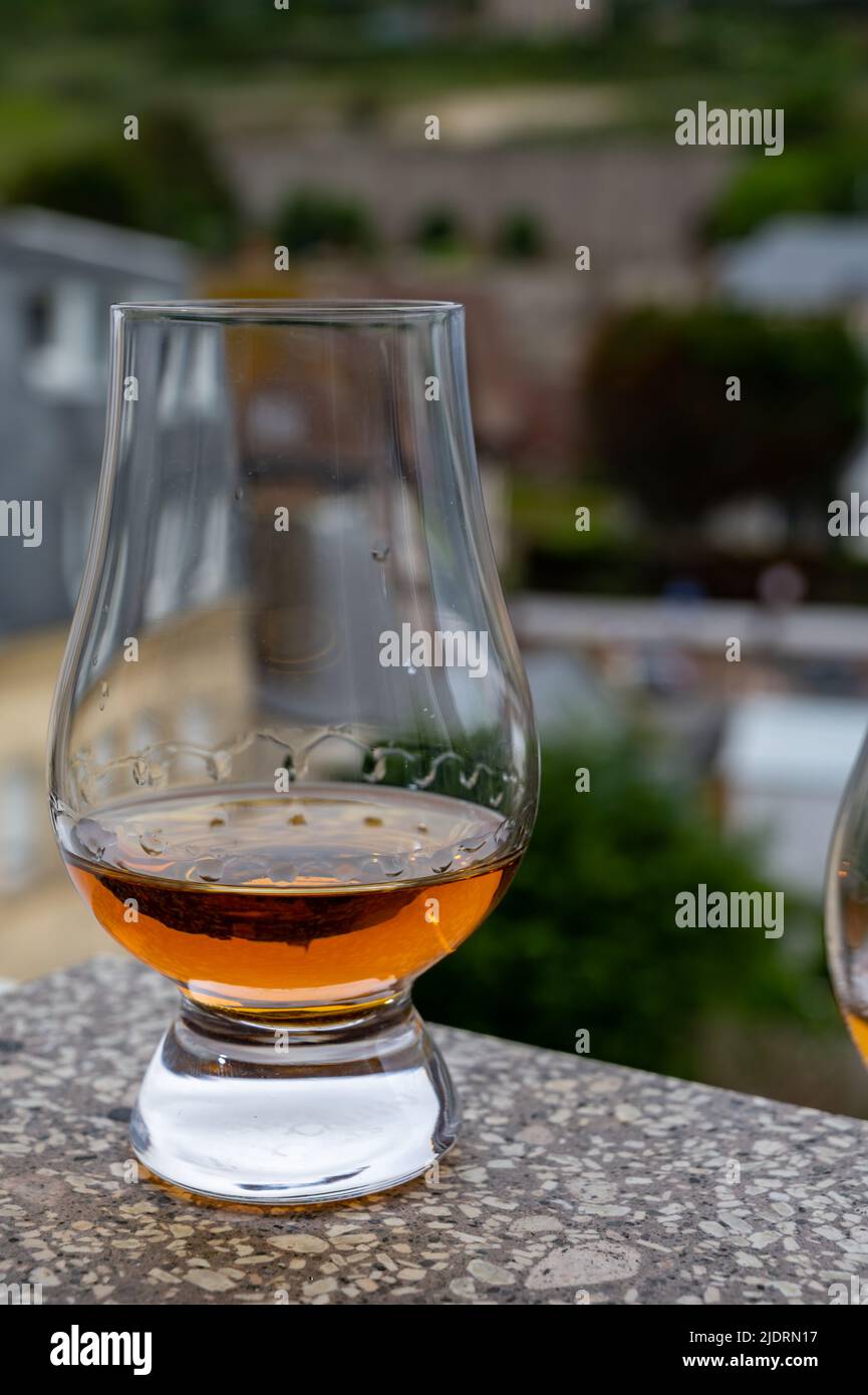 Dram of scotch whiskey with view on old houses on background, Edinburgh ...