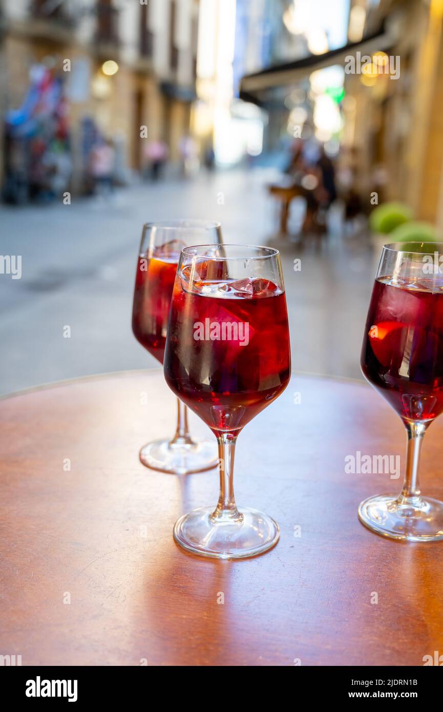 Glasses of cold sangria wine served outdoor in bar with view on old ...