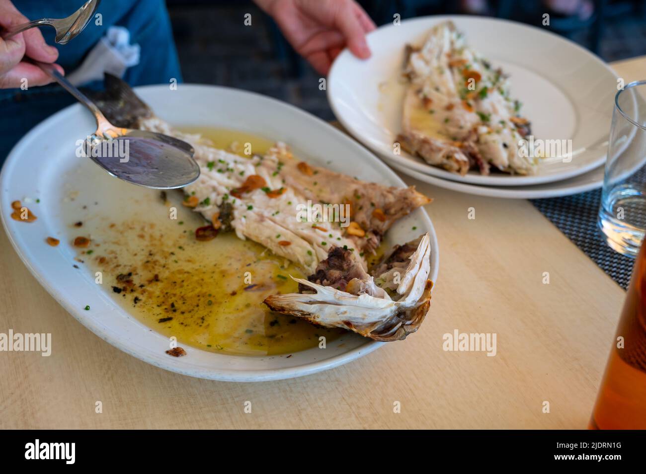 Serving in restaurant of fresh grilled with garlic and olive oil on old ...