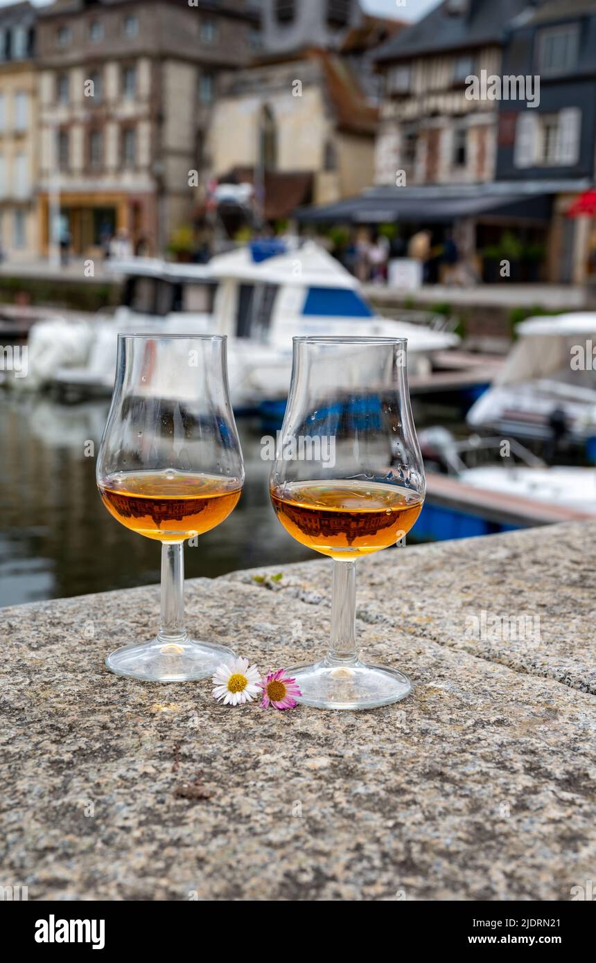 Tasting of apple calvados drink from glasses in old Honfleur harbour ...