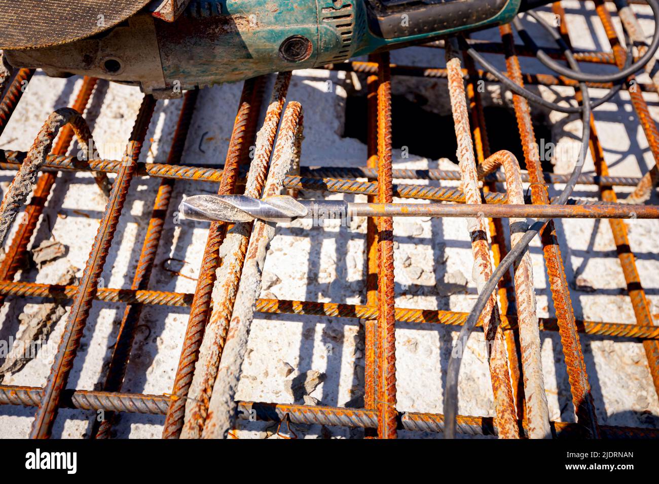 A manually electrical grinder and drill for concrete set on rusty ...