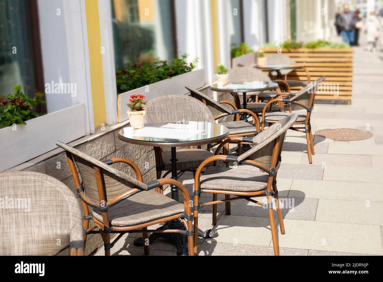 Cafe table on the street wicker chair and round table, urban restaurant ...