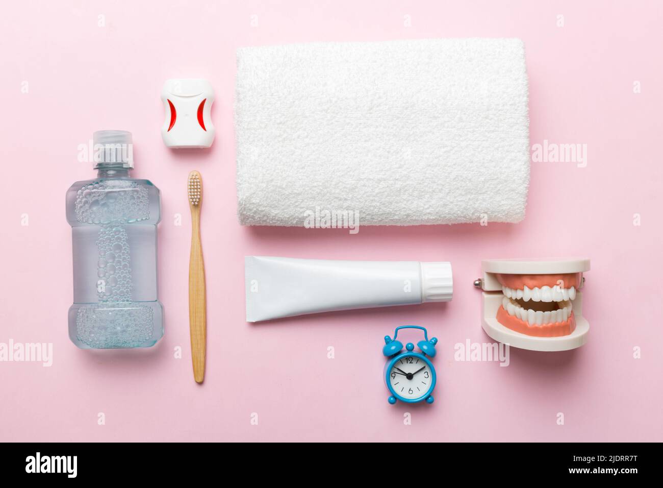 Mouthwash and other oral hygiene products on colored table top view ...