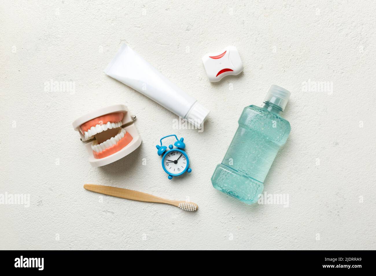 Mouthwash and other oral hygiene products on colored table top view ...