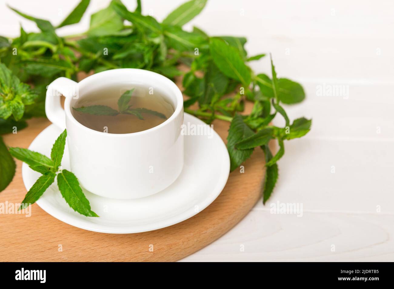 Cup of mint tea on table background. Green tea with fresh mint top view ...
