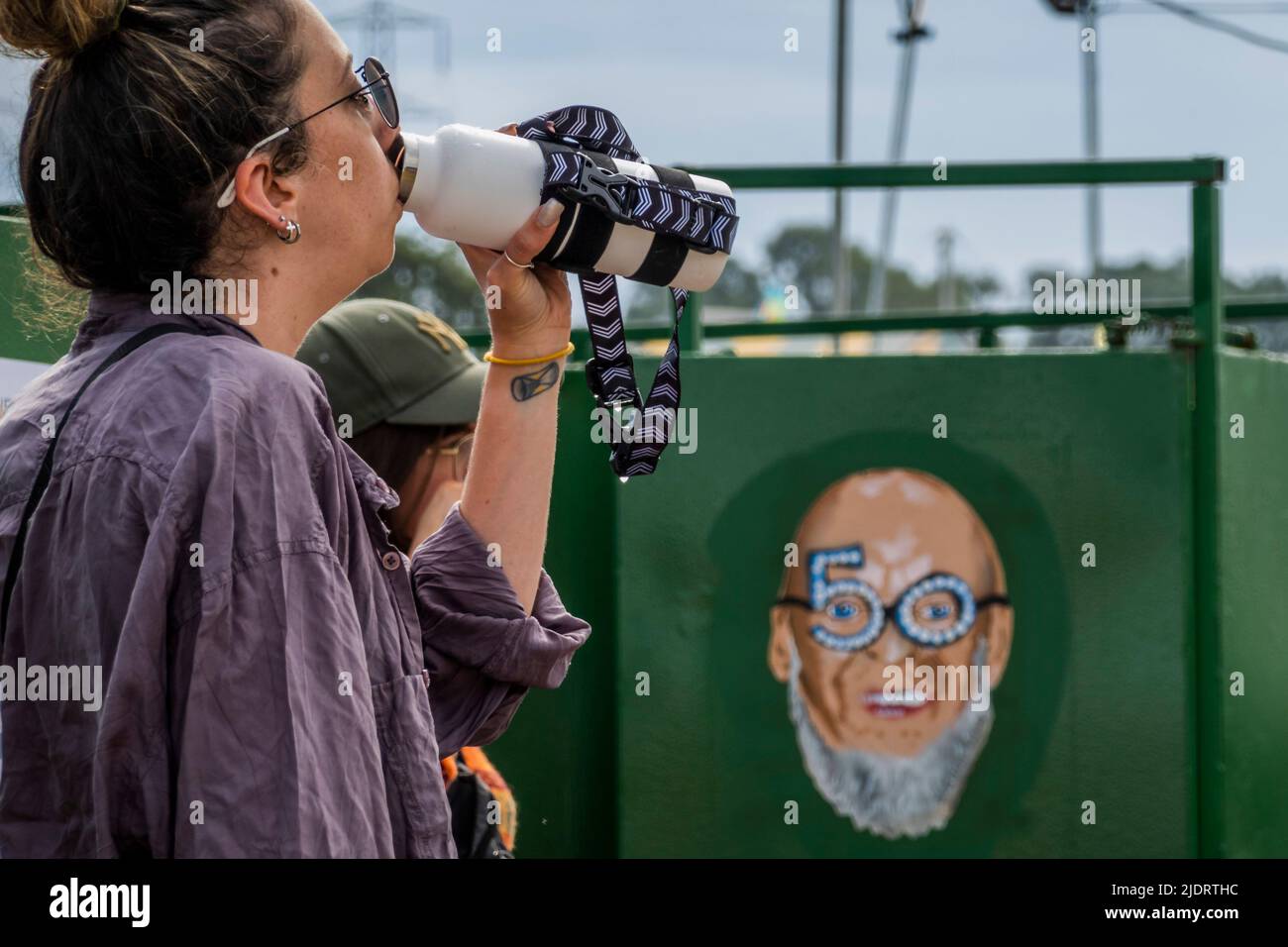 Glastonbury, UK. 23rd June, 2022. Keep hydrated as Michael Evis ...