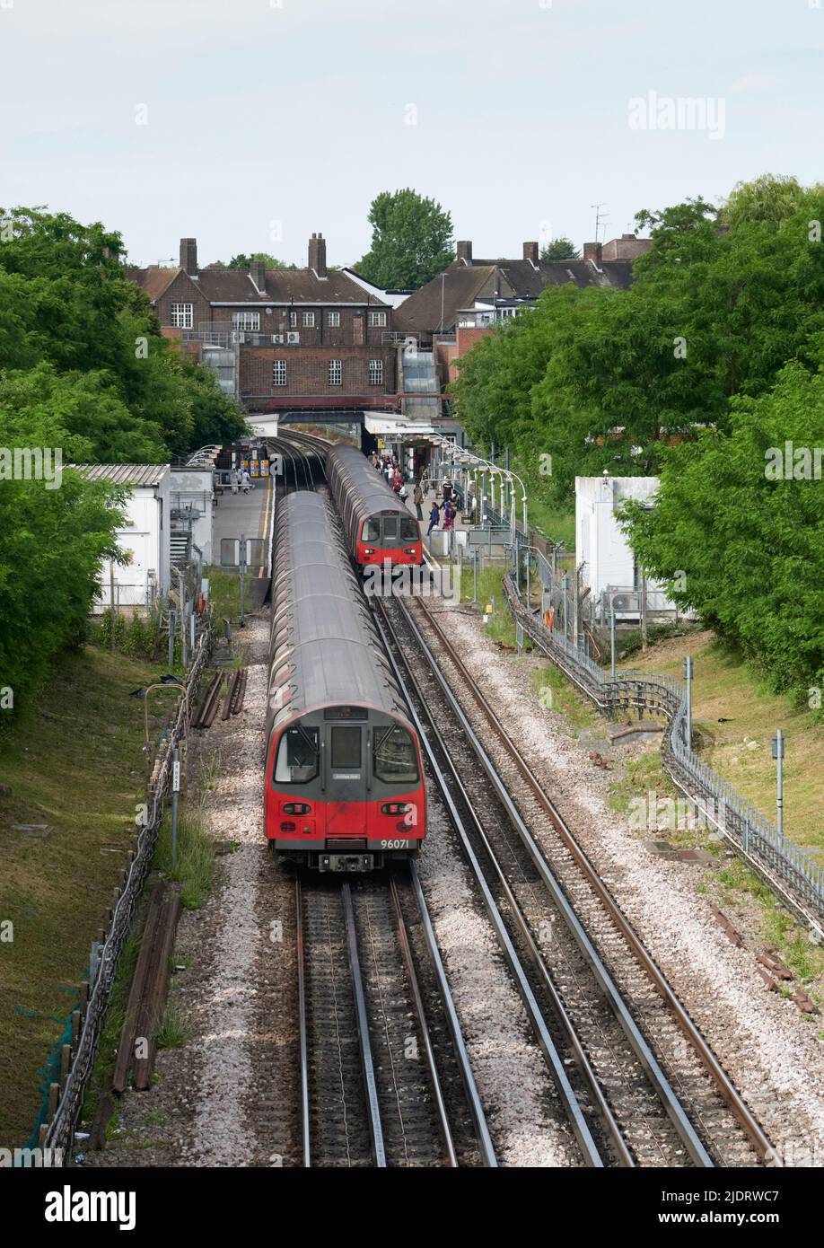 Trains of 1996 rolling stock pass near Kingsbury station on afternoon London Underground Jubilee ...