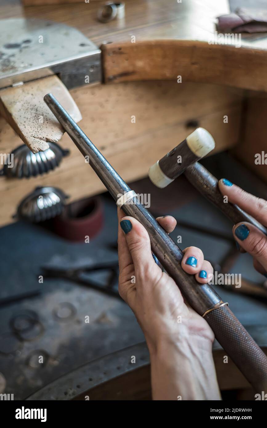 A Goldsmith Working On Unfinished Ring With His Hammer Stock Photo - Alamy