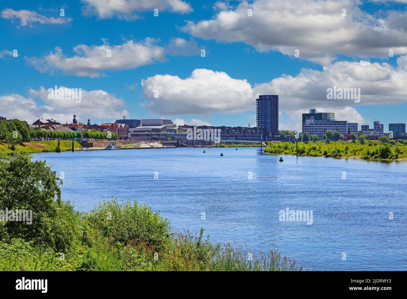 Beautiful cityscape of dutch riverside town, scenic rural river Maas ...