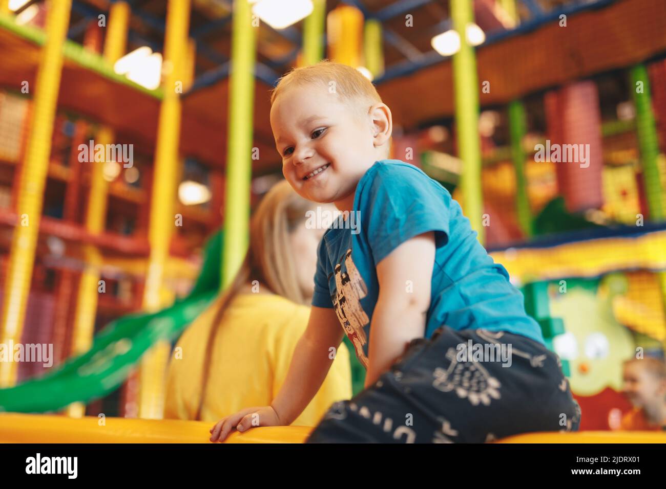 Happy little child boy laughing at amusement park. Boy having fun at ...