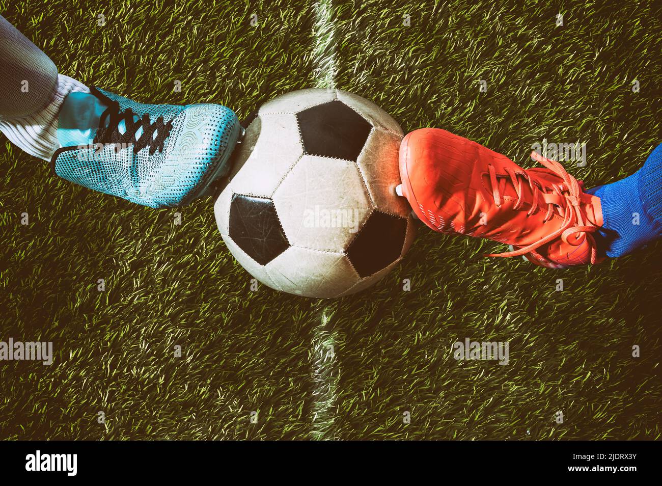 Two soccer players challenge each other at the stadium Stock Photo - Alamy