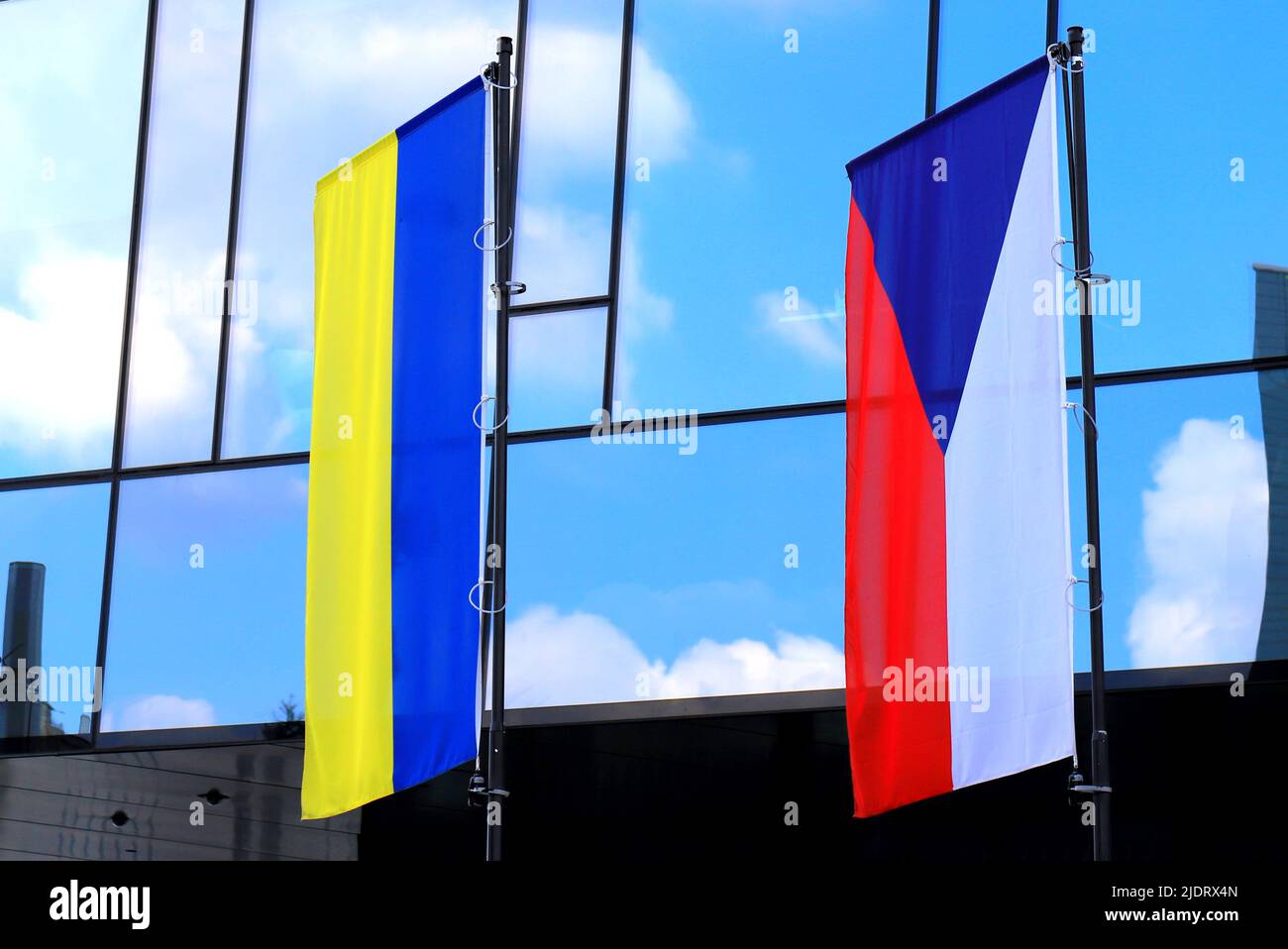 State flags of Czech Republic and Ukraine near modern building in ...