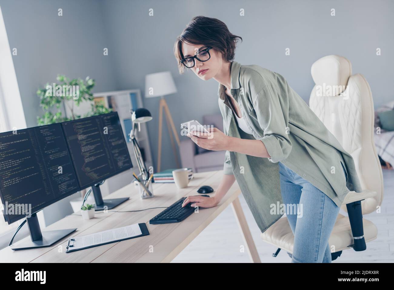 Portrait of attractive skilled focused intelligent girl hacker tech ...