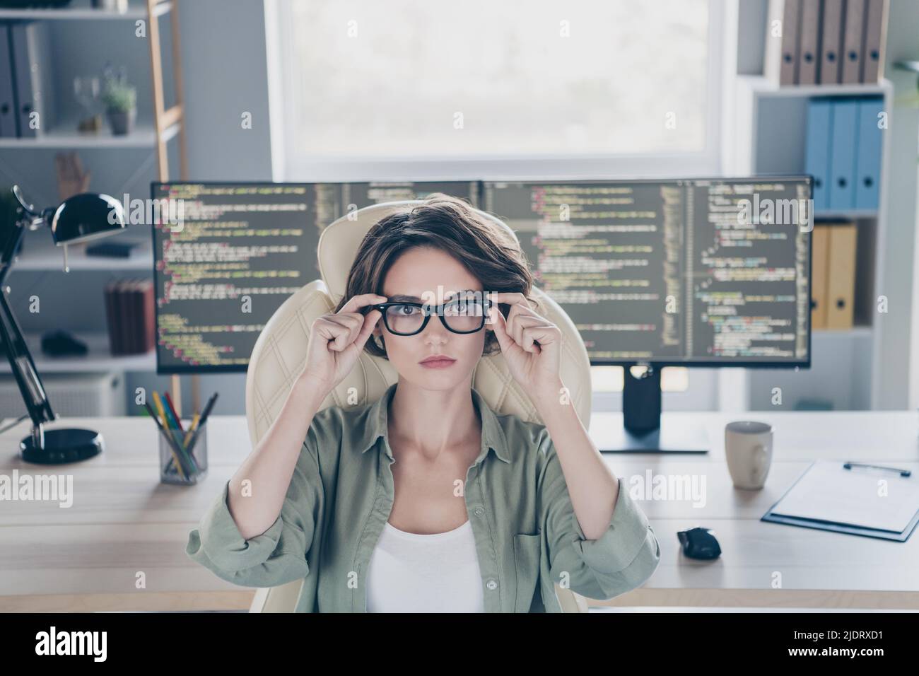 Photo of calm focused lady sitting chair hands touch spectacles ...
