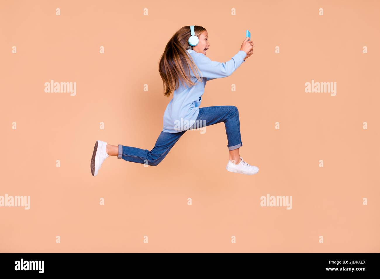 Full body profile photo of carefree energetic pupil run jump hold ...