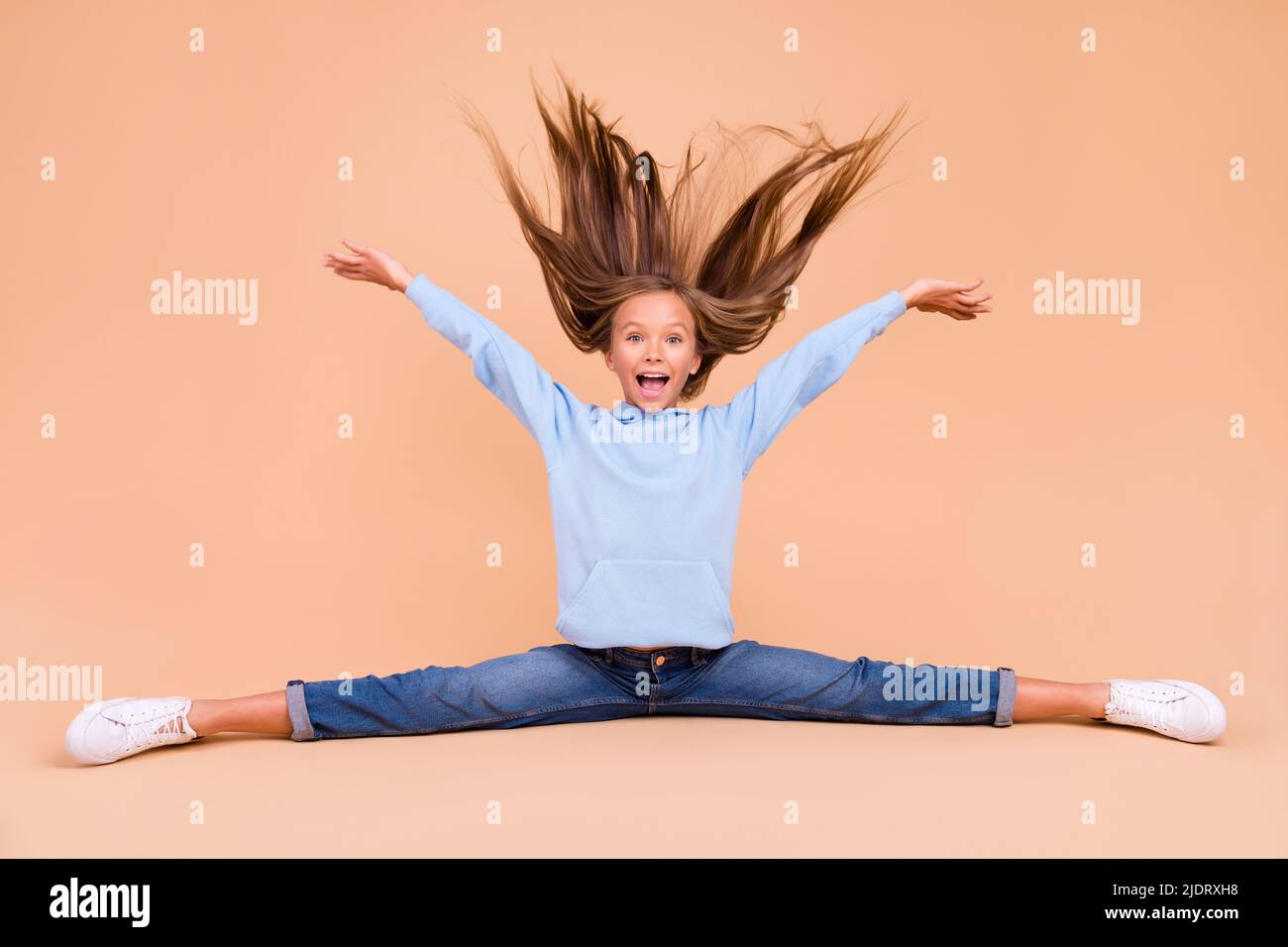 Full length photo of excited funky girl sit floor split legs hands ...