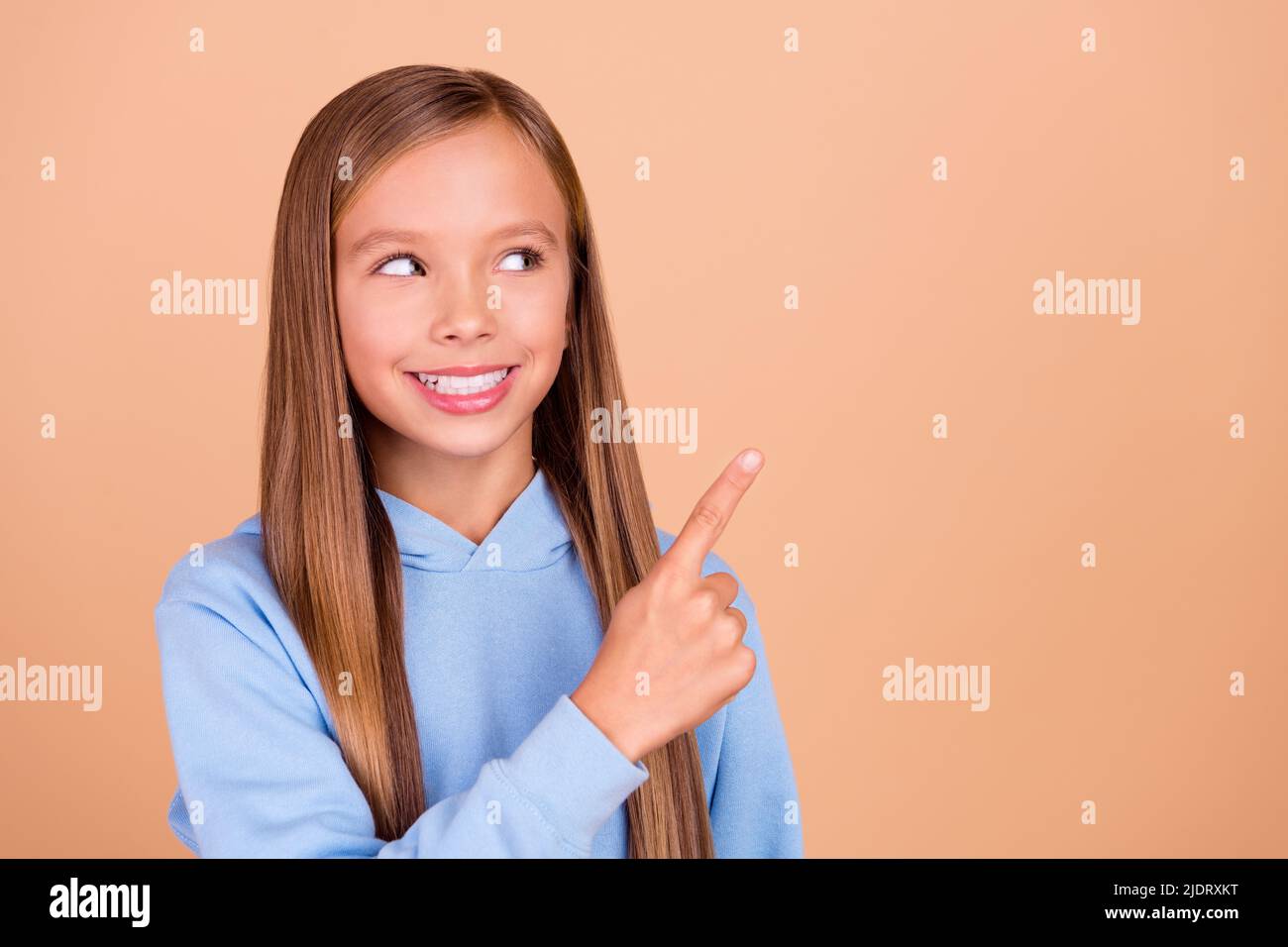 Portrait of cheerful nice pupil look indicate finger empty space ...