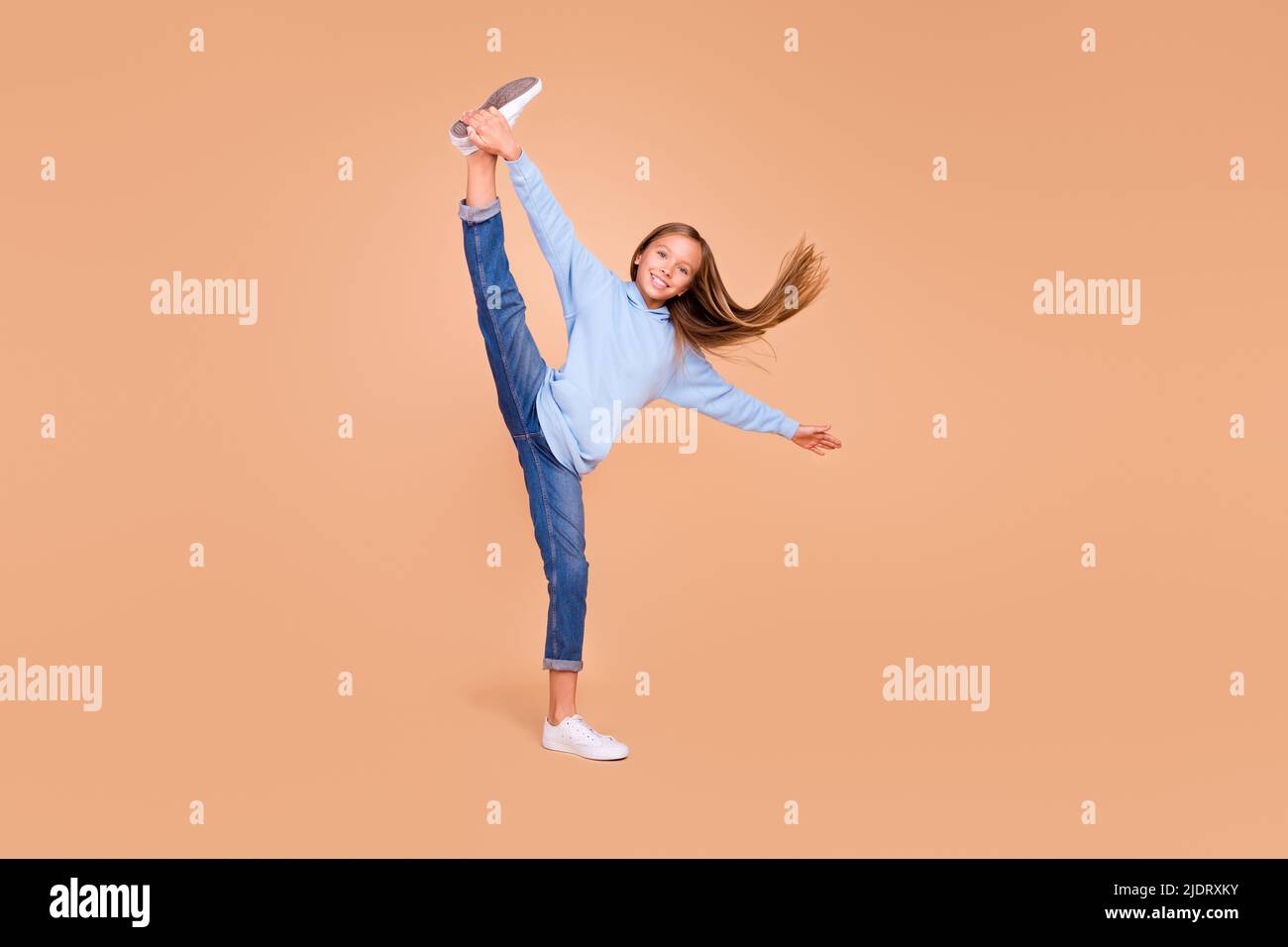 Full body portrait of excited cheerful girl hand hold one split leg ...