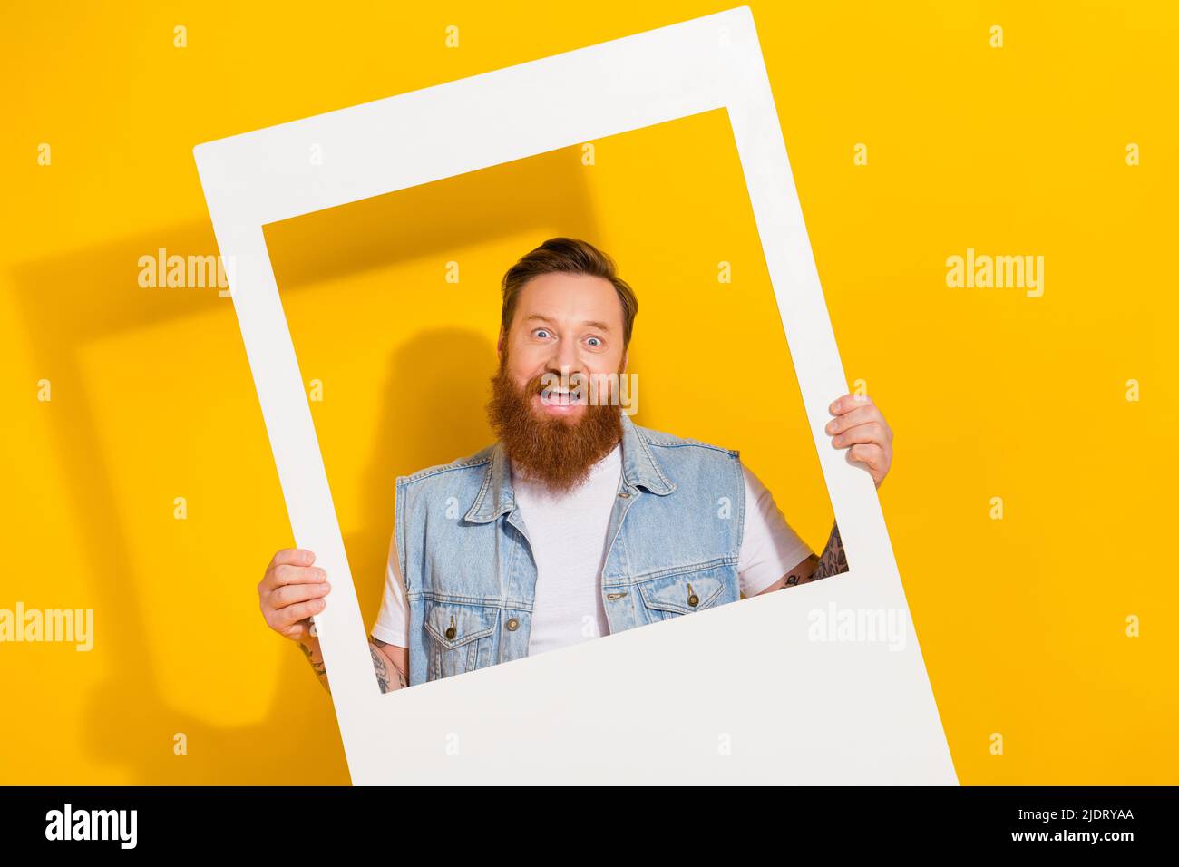 Photo of impressed funky guy dressed denim vest holding looking white ...