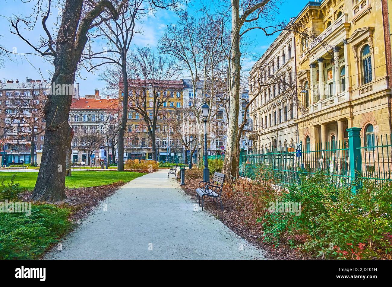 Walk the scenic spring Museum Garden with green grass, tall trees ...