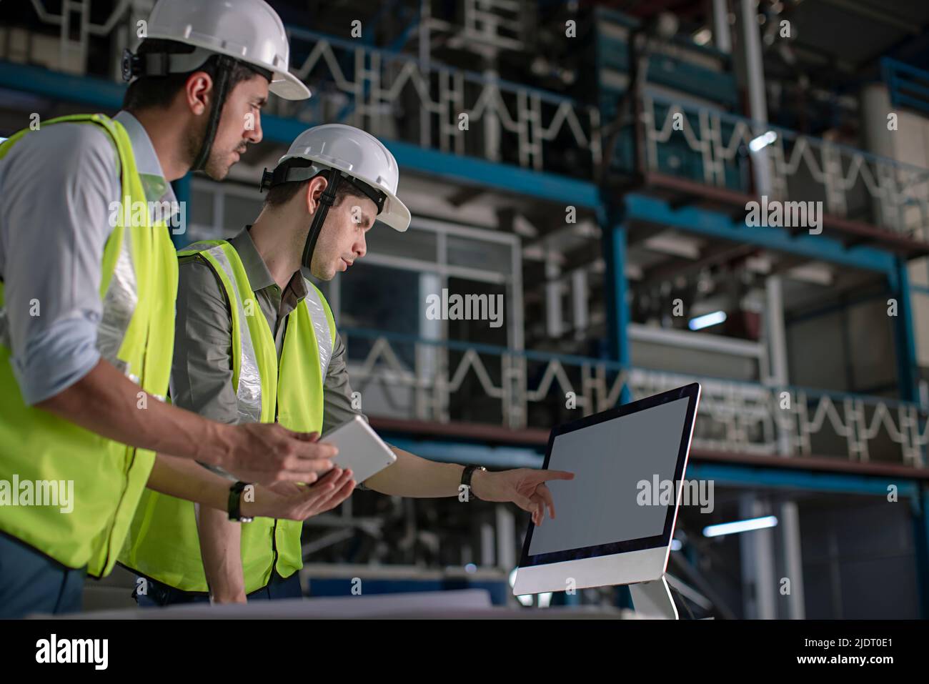 Two engineers looking at computer hi-res stock photography and images ...