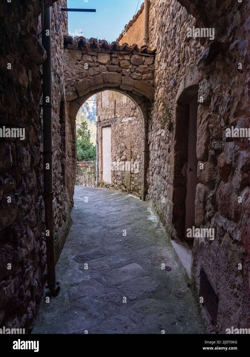 Arched passage way through the medieval streets of the Provençal ...